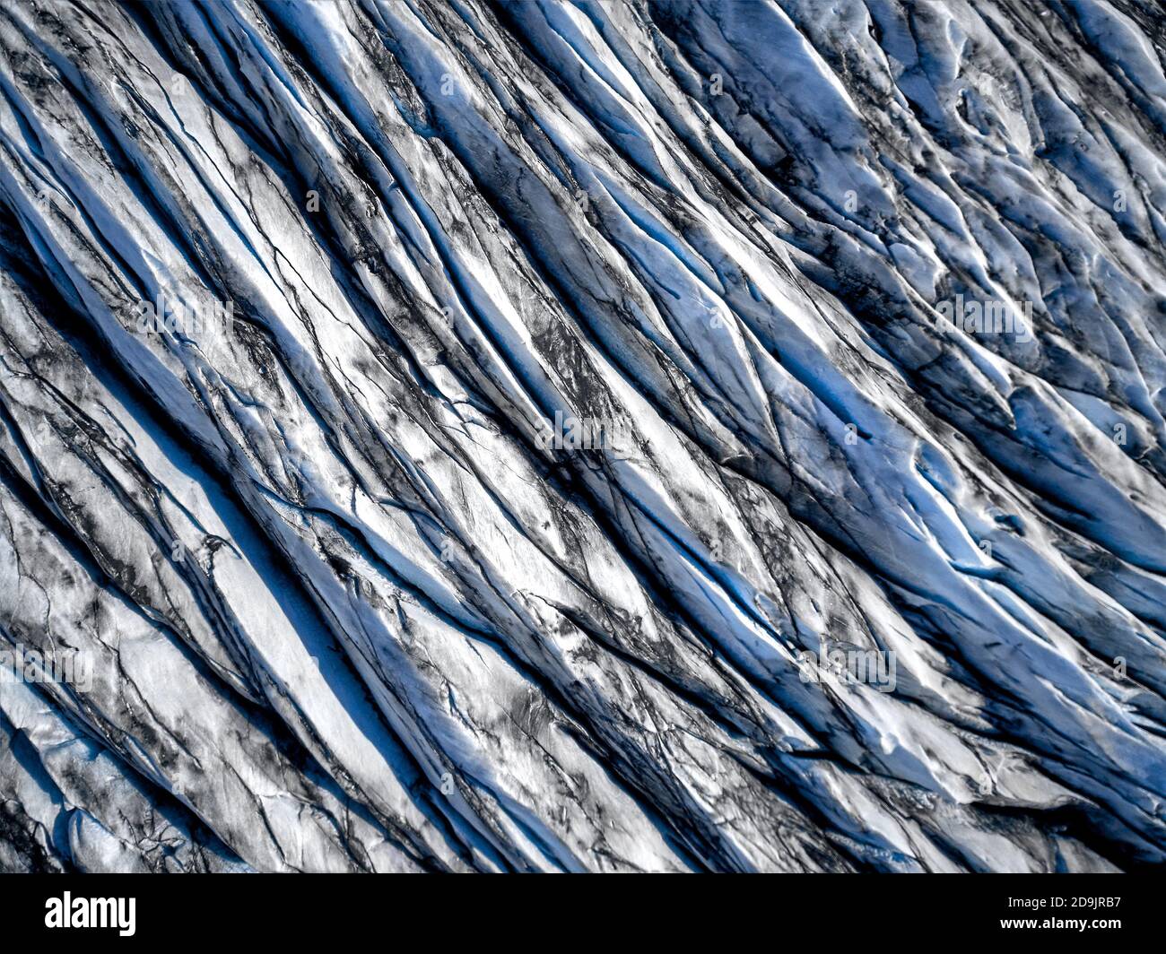 Aerial view of glacier from above, ice and ashes of the volcano texture ...