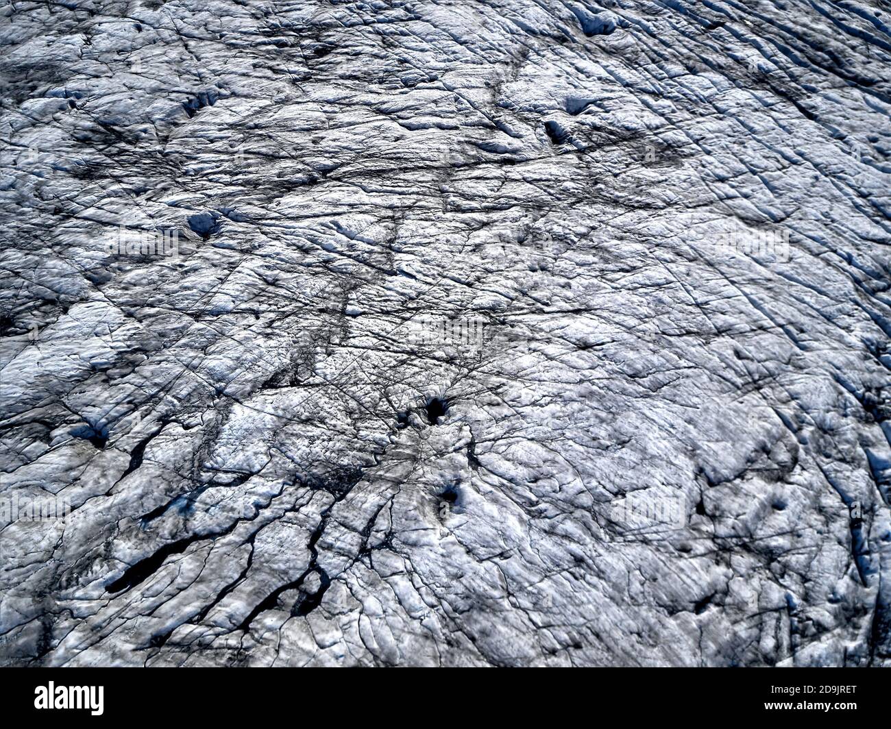 Aerial view of glacier from above, ice and ashes of the volcano texture ...
