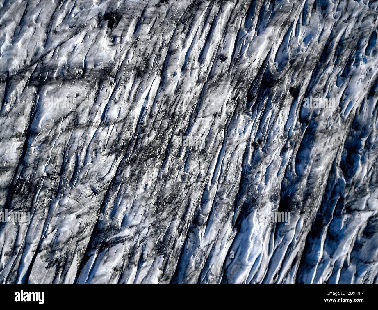 Aerial view of glacier from above, ice and ashes of the volcano texture ...