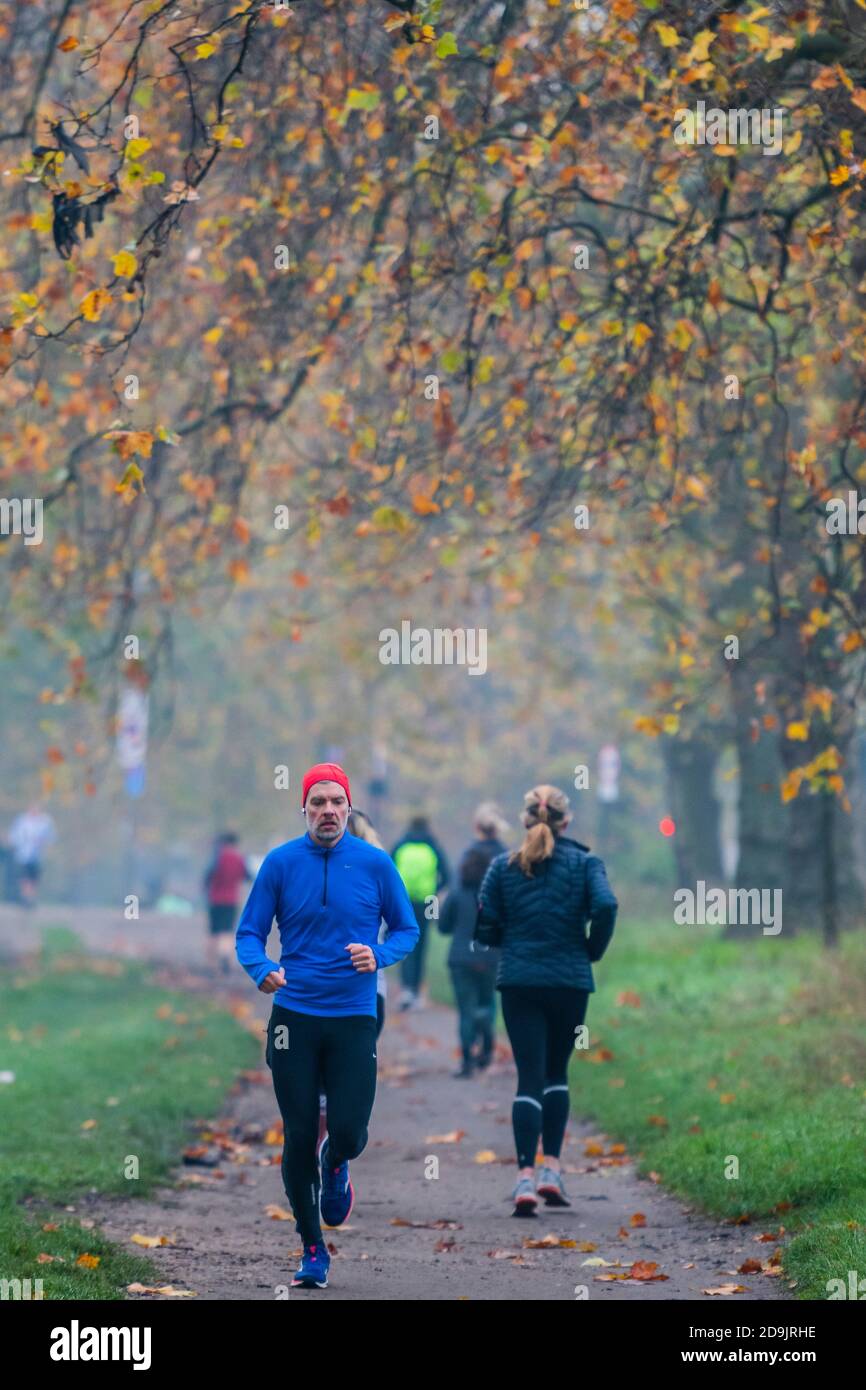 London, UK. 06th Nov, 2020. On a misty morning, Clapham Common is busy ...