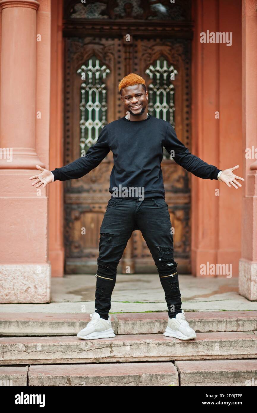 African red haired man wear black outfit posing outdoor Stock Photo - Alamy