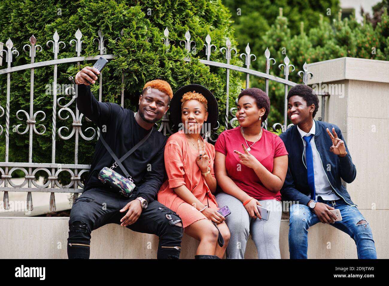 Four african friends having fun outdoors. Two black girls with guys ...