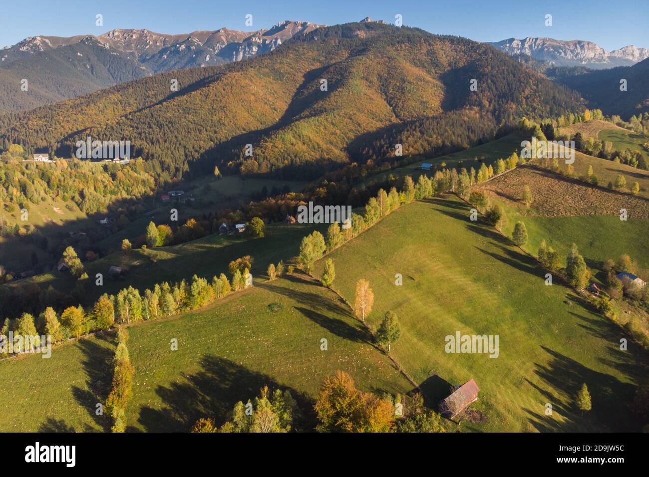 Autumn rural scene of the Romanian village in Transylvania, at the foot ...