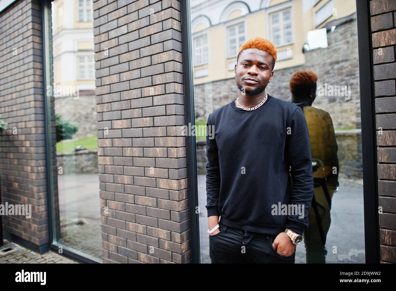 African red haired man wear black outfit posing outdoor Stock Photo - Alamy