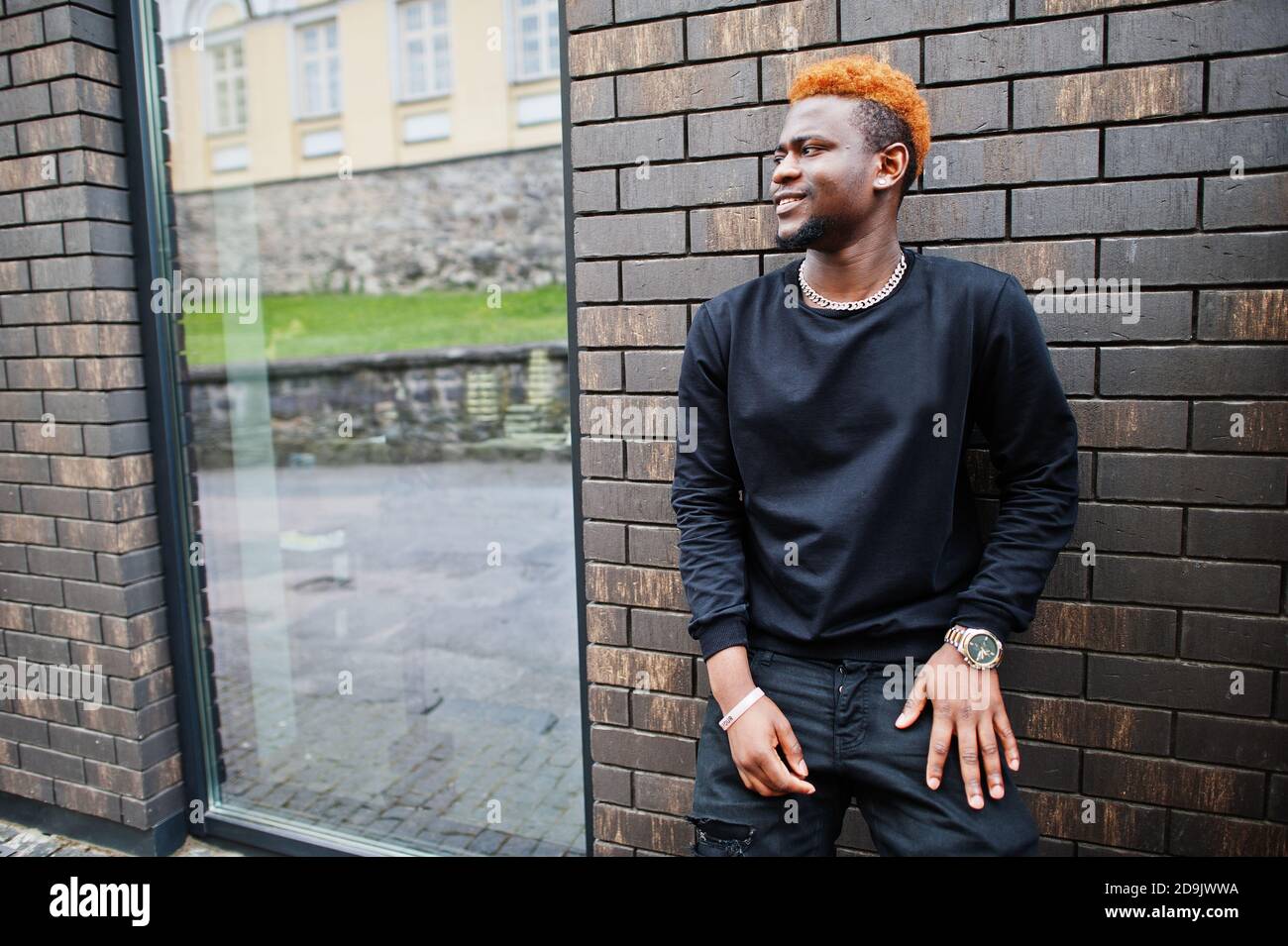 African red haired man wear black outfit posing outdoor Stock Photo - Alamy