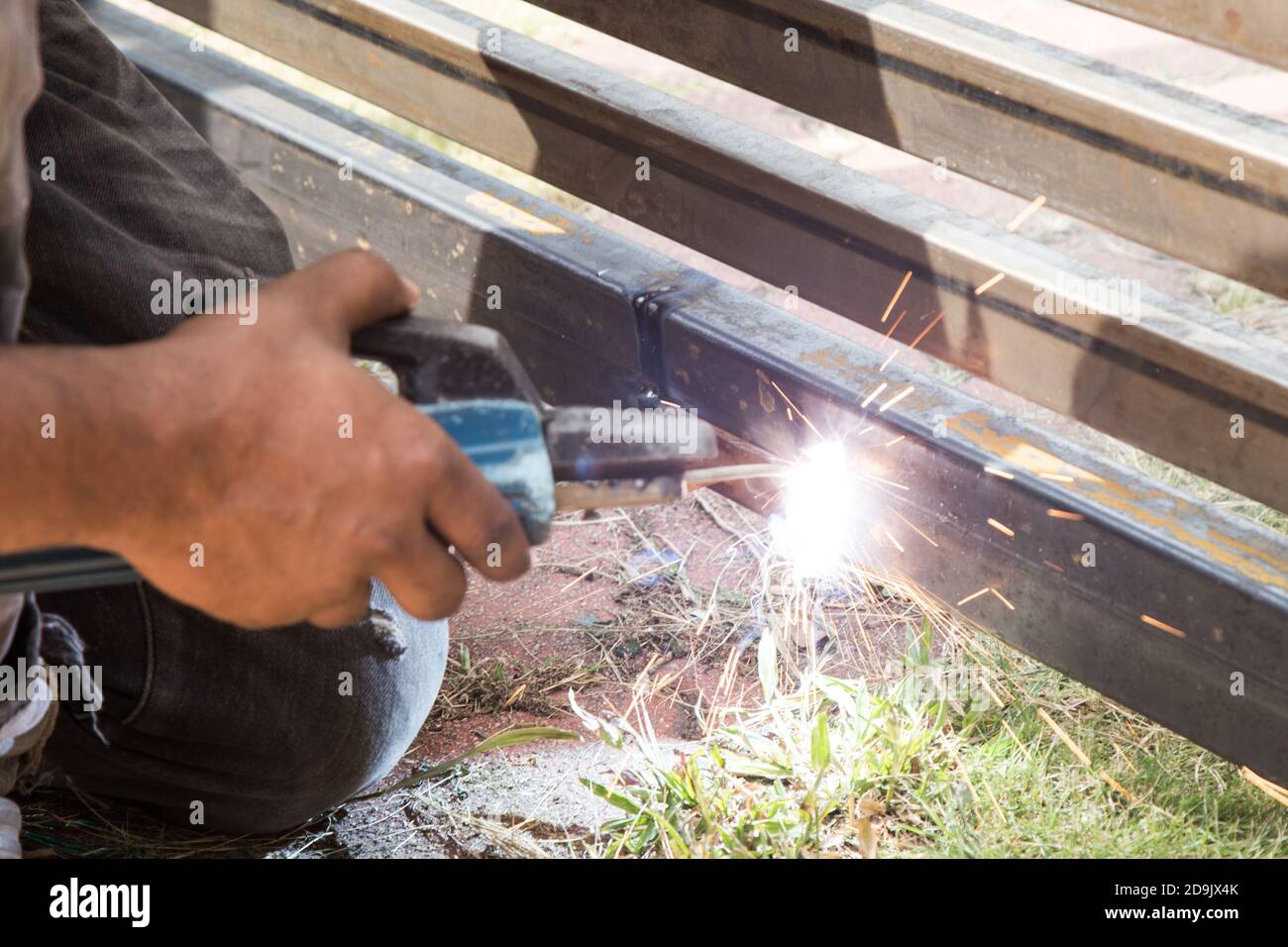 Closeup of worker welding auto gate arm onto metal gate Stock Photo - Alamy