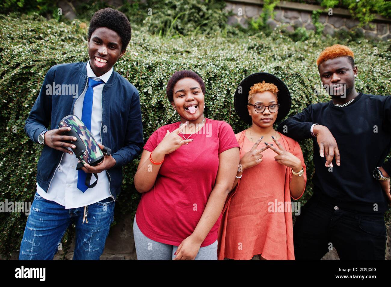Four african friends having fun outdoors. Two black girls with guys ...