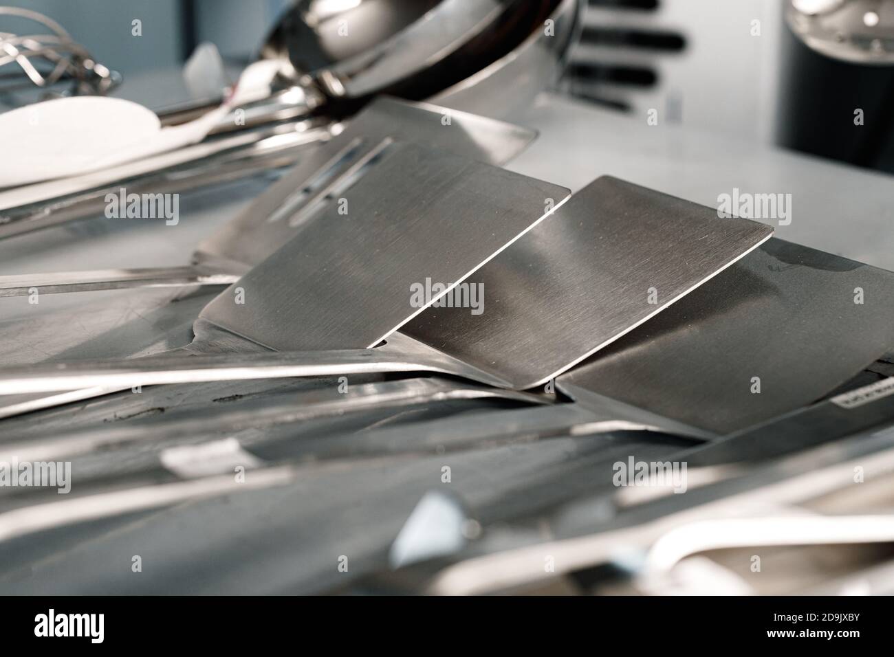 New metal kitchenware in a row close up Stock Photo - Alamy