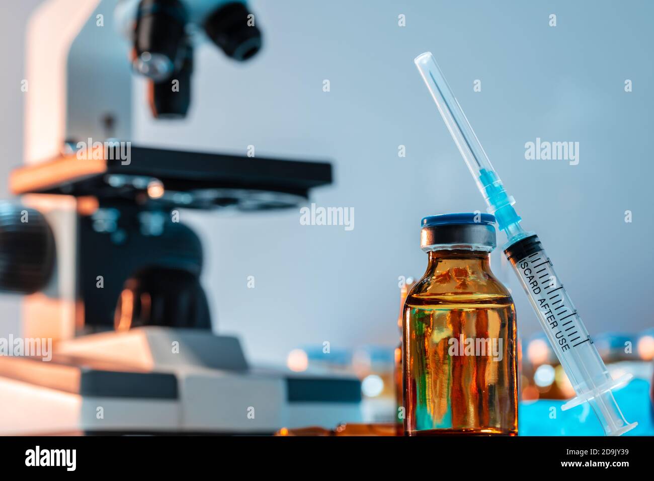 Medical vial with medication near microscope photo Stock Photo - Alamy