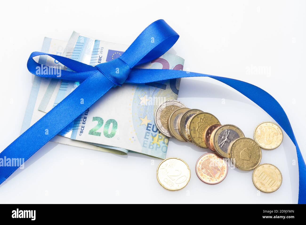Euro notes and coins decorated with gift bows; give away money at ...