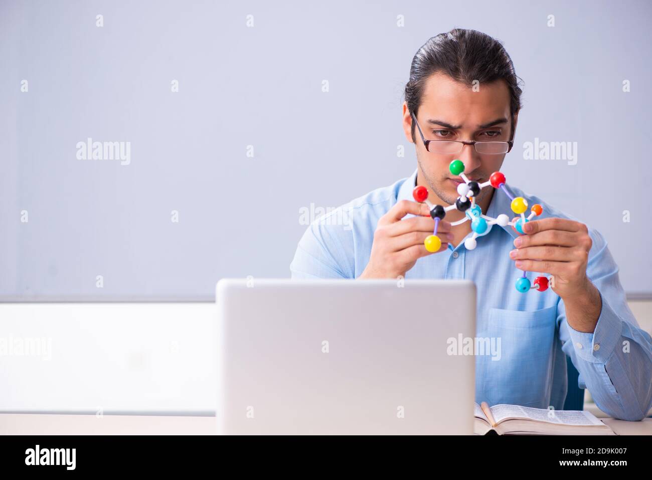 Young physics teacher in front of whiteboard Stock Photo - Alamy