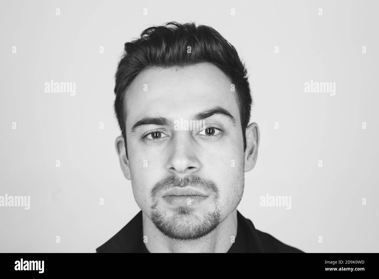Close up studio portrait of a young caucasian man in a black jacket ...