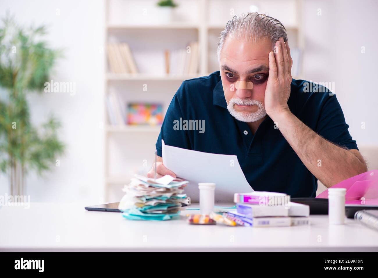Old man in budget planning concept Stock Photo - Alamy