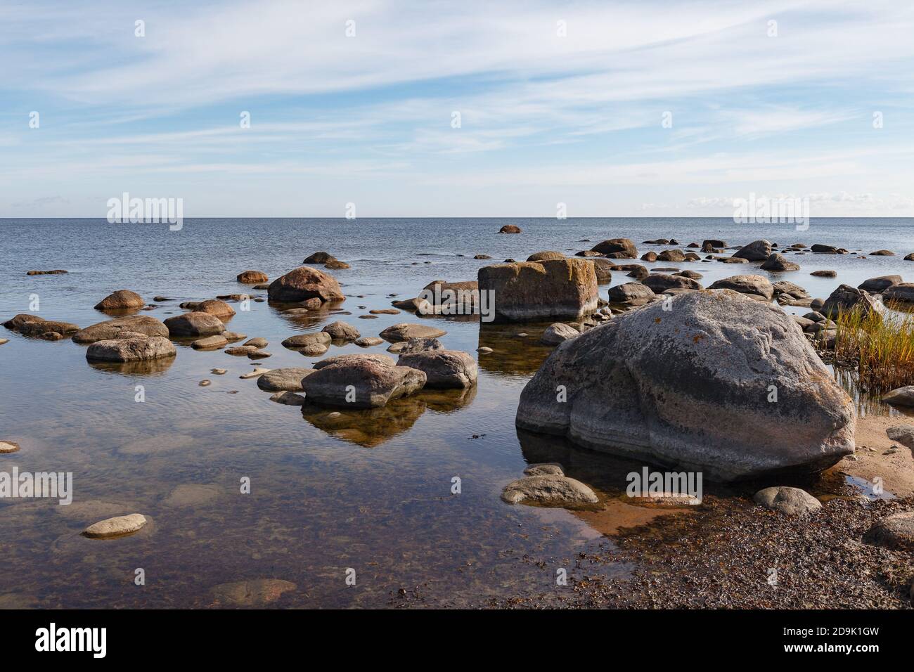 Granite stones on the beach of the Gulf of Finland in bright summer day ...