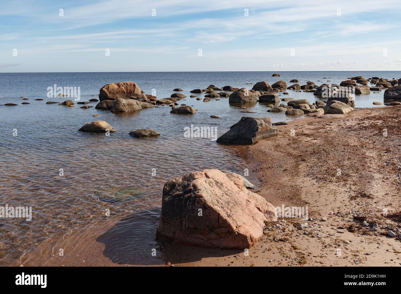 Granite stones on the beach of the Gulf of Finland in bright summer day ...