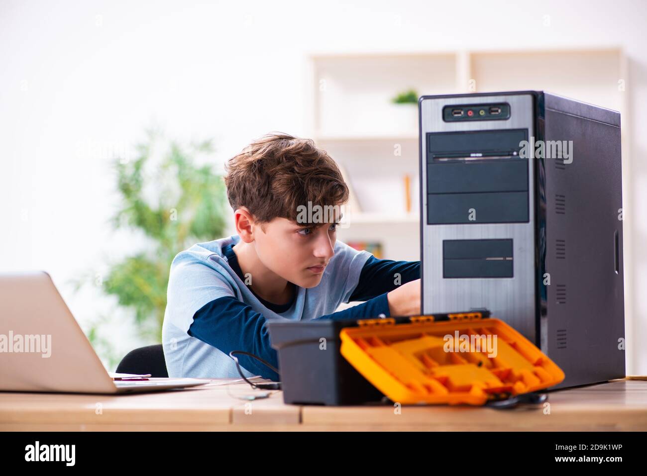 Teenager reparing computers at workshop Stock Photo - Alamy