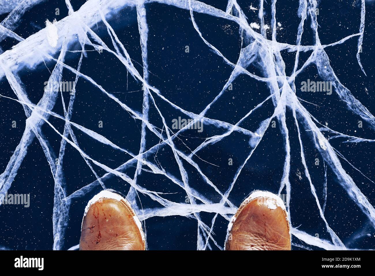 Human feet in boots on the ice lake Baikal. blue lake ice Stock Photo ...