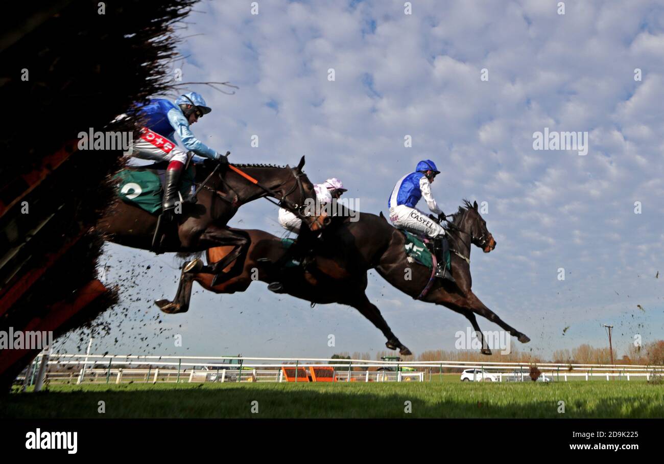 Runners and riders jump a fence on the first lap during the racingtv ...