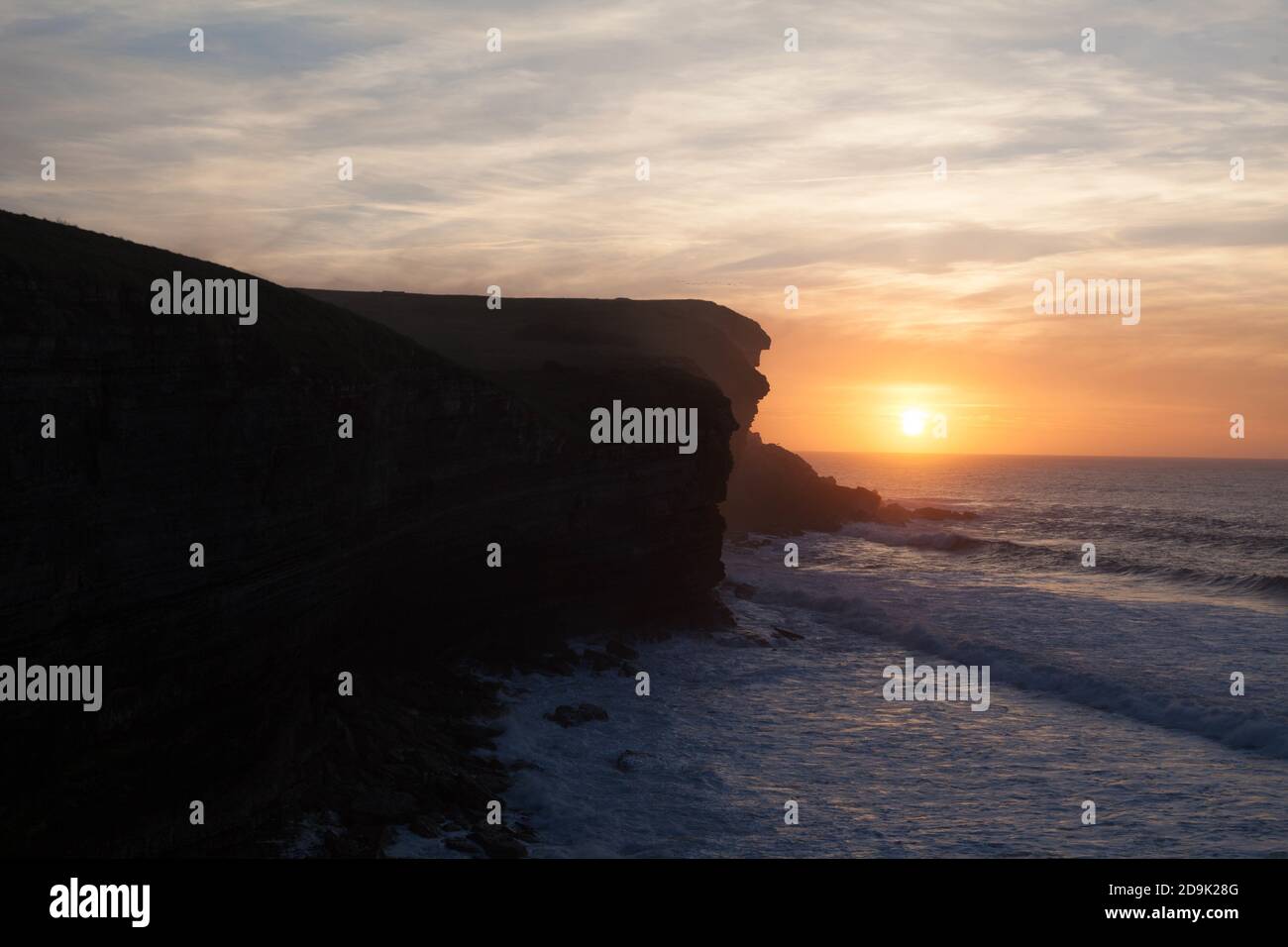 Amazing shot of a beautiful coastal cliff on a seaside sunset ...