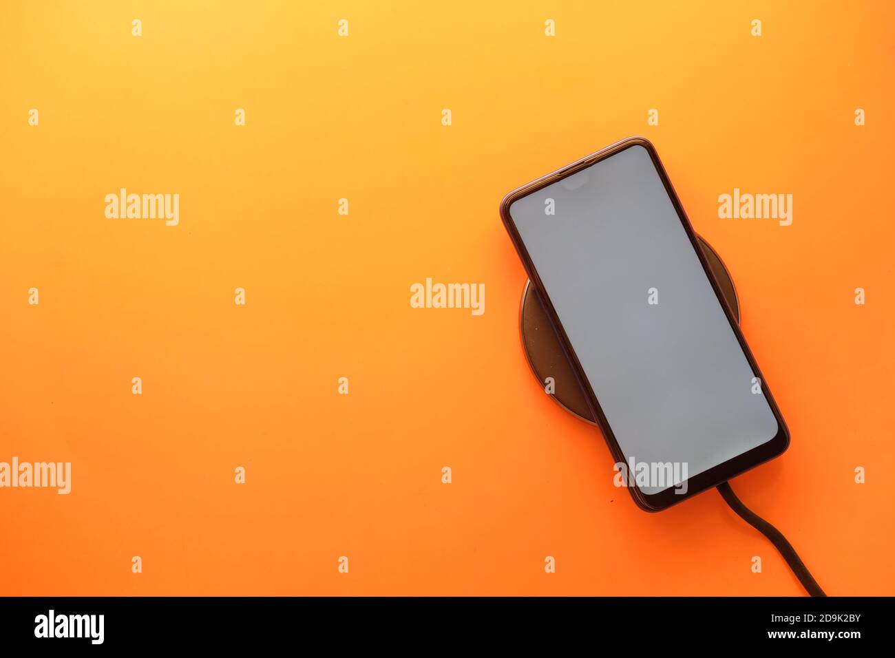charging Smartphone Using Wireless Charging Pad, top view Stock Photo ...