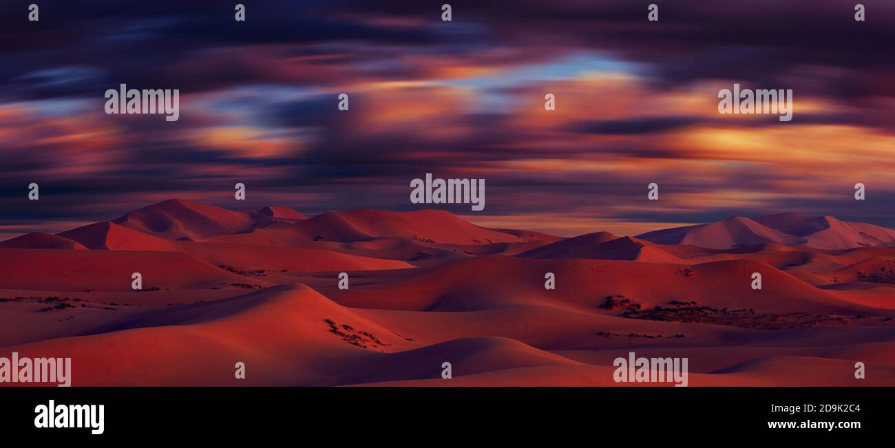 Beautiful sand dunes and Clouds in motion. Long exposure at sunset ...