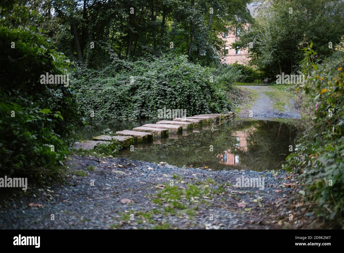 Small bridge made with stones on a river Stock Photo - Alamy