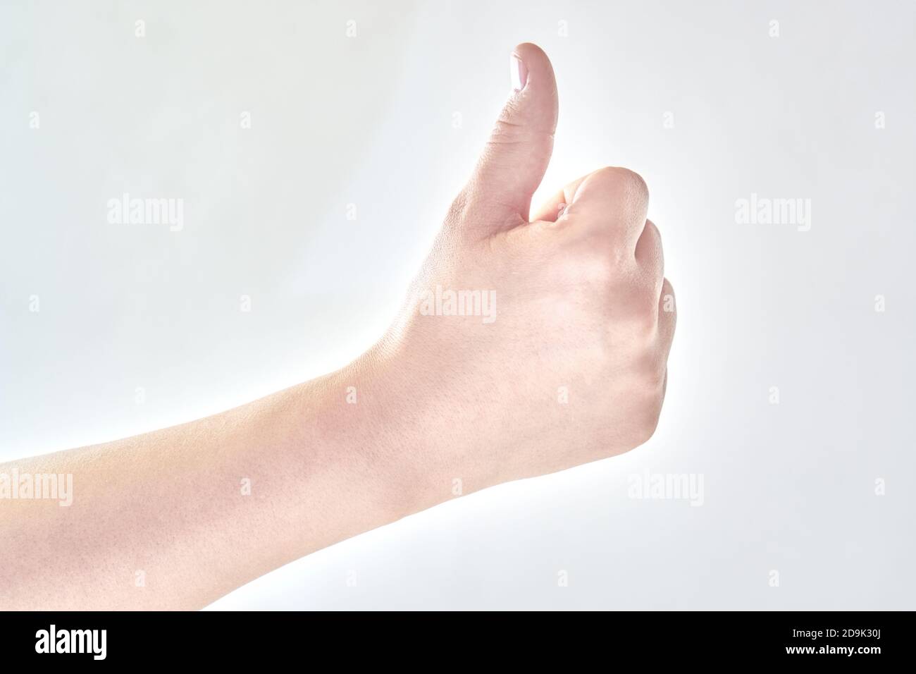 A closeup shot of a man doing thumbs up on an isolated white background ...