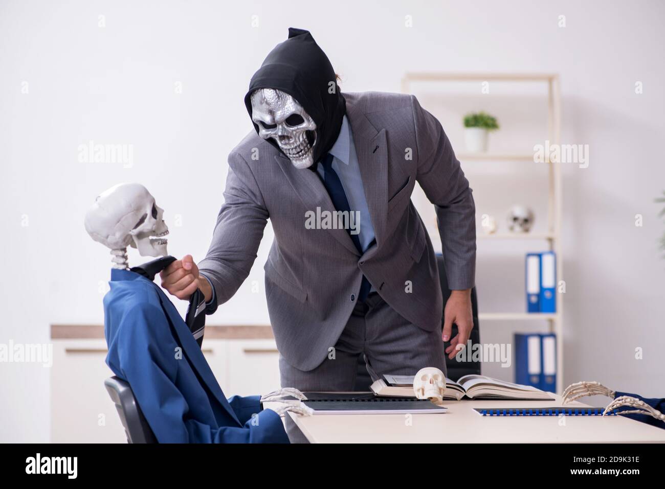 Funny business meeting with the devil and skeletons Stock Photo - Alamy