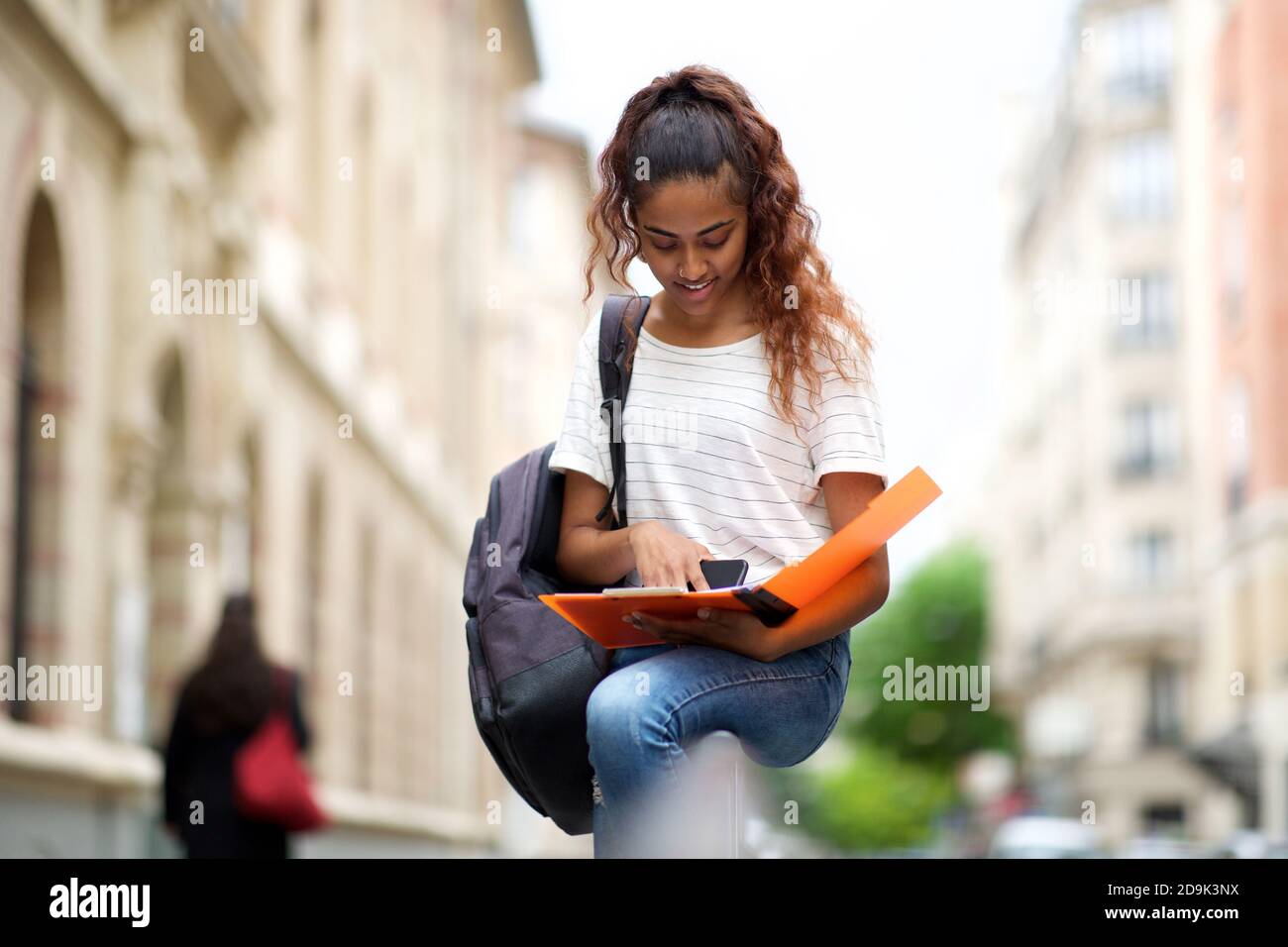 Portrait female university student reading notes outdoors Stock Photo ...