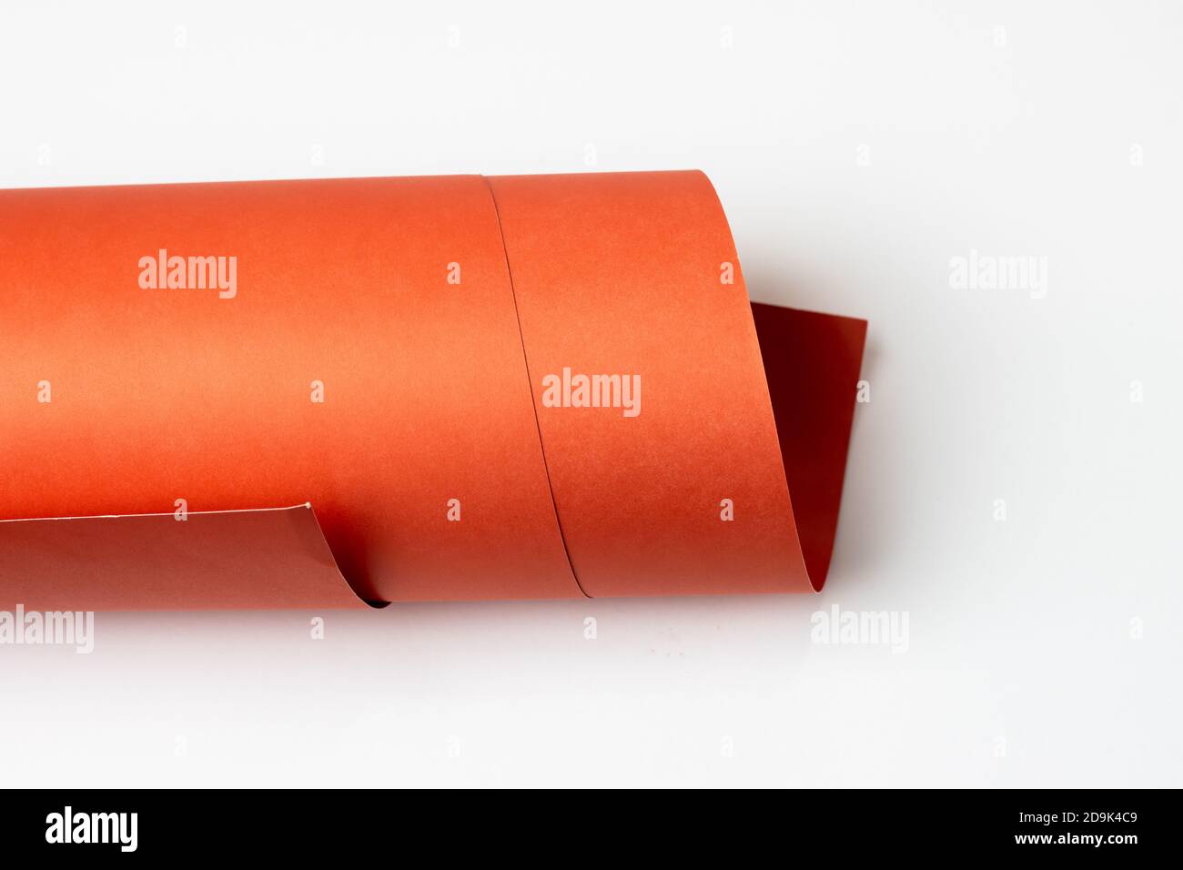 Isolated rolled red textured art paper on white background Stock Photo ...