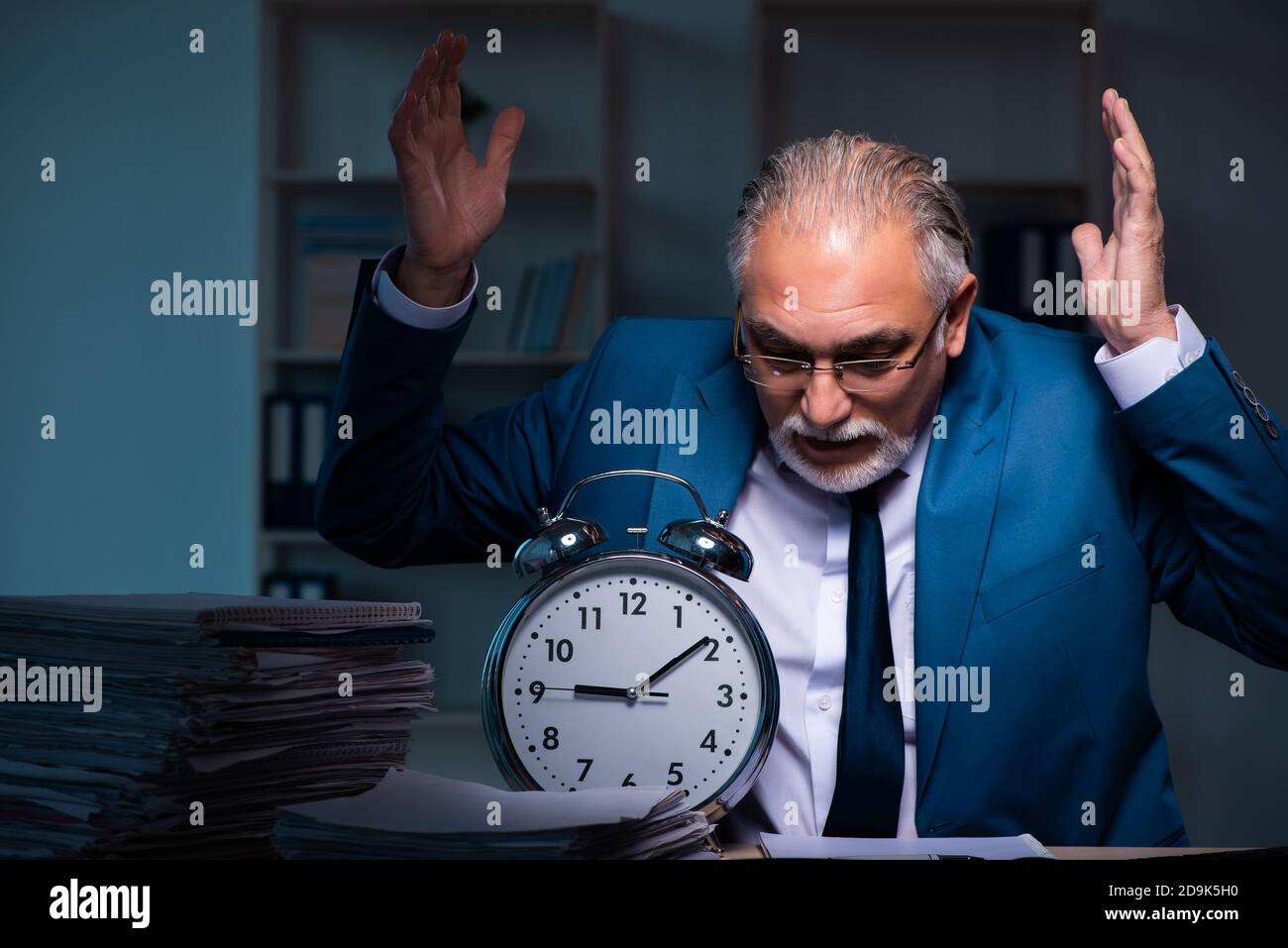 Old employee working late in the office Stock Photo - Alamy