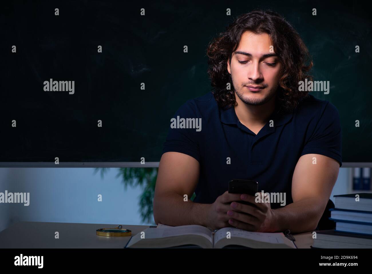 Young student in the classroom at night Stock Photo - Alamy