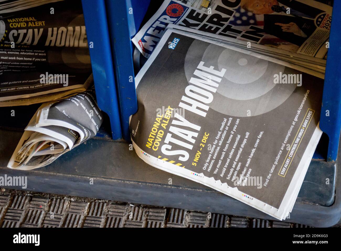 Stay home, newspaper message on paper in stand. Crumpled newspapers on ...