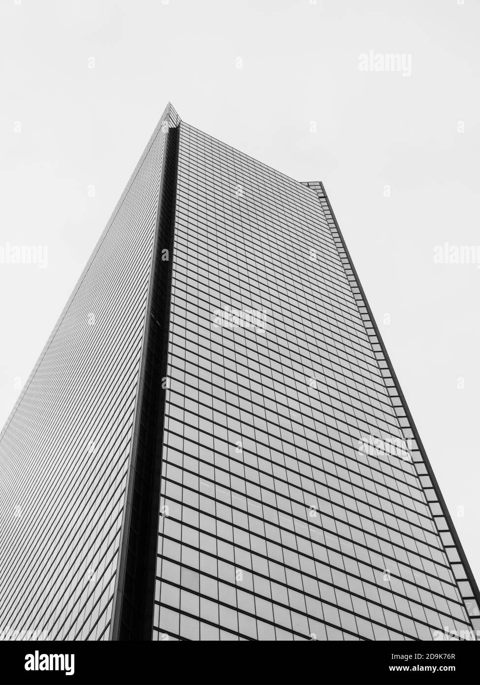 Vertical low angle shot of a modern office building in grayscale Stock ...