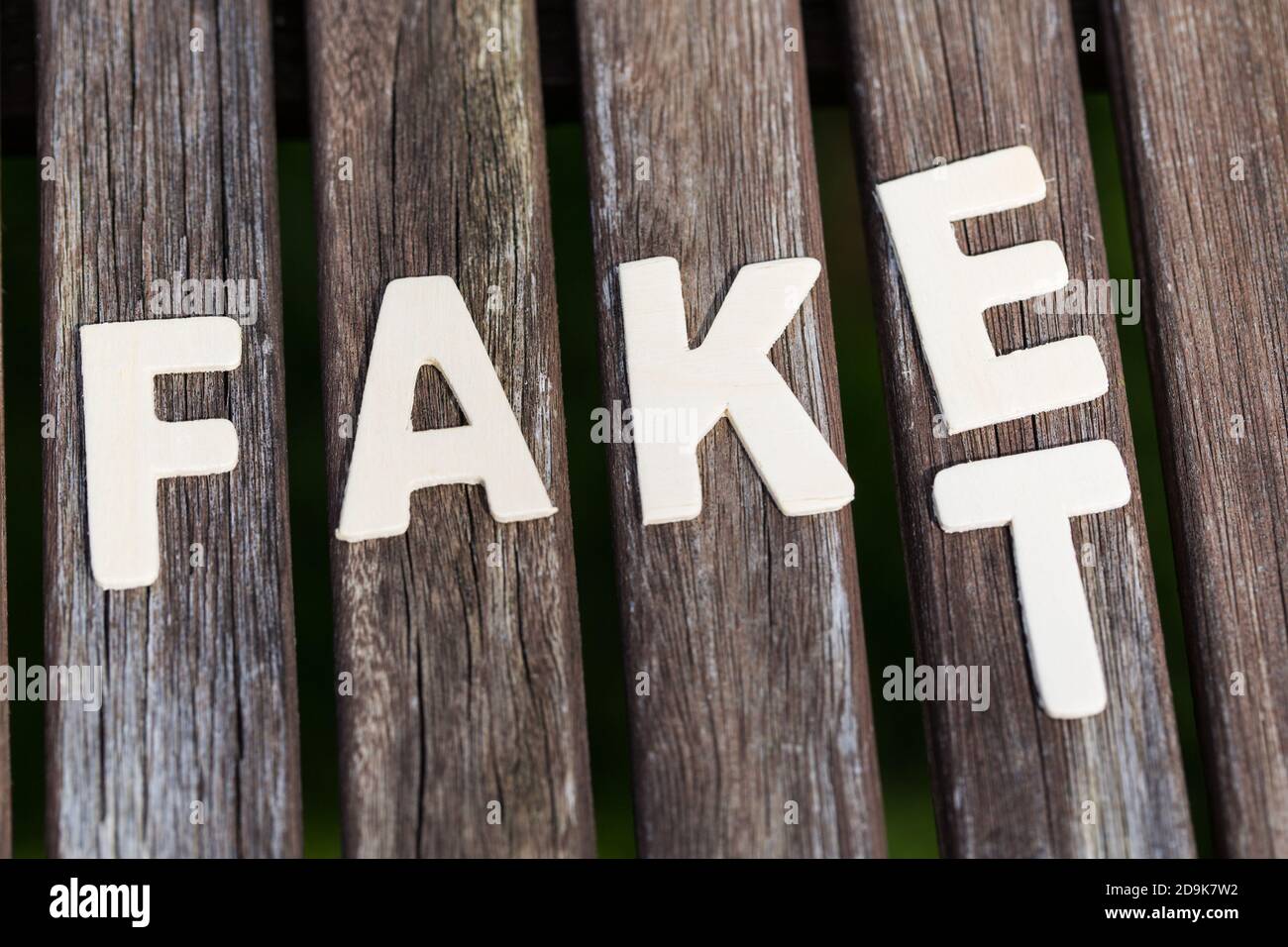 Fake, fact, as text, letters on wood Stock Photo - Alamy