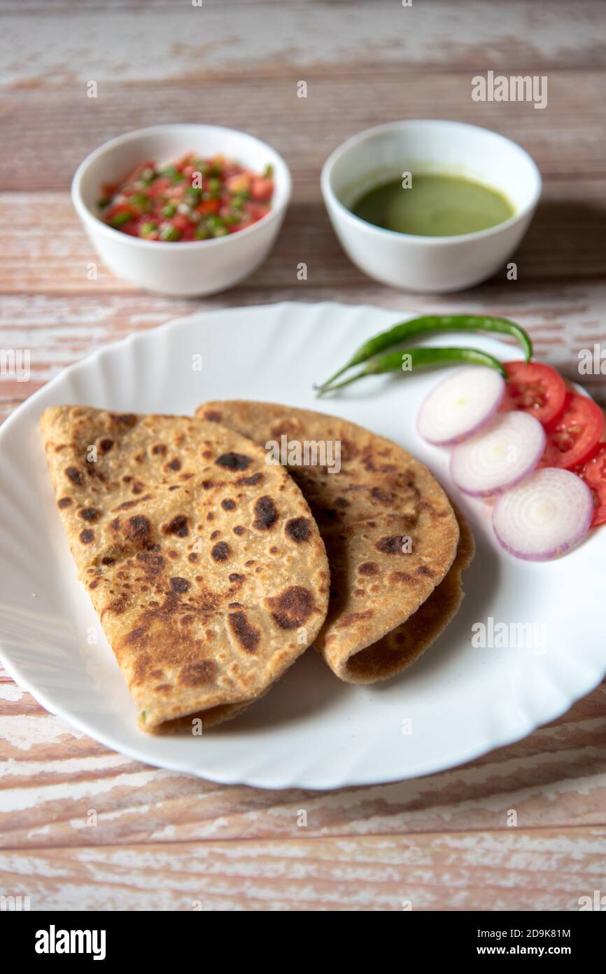 Vertical top view of alu paratha along with breakfast condiments Stock ...