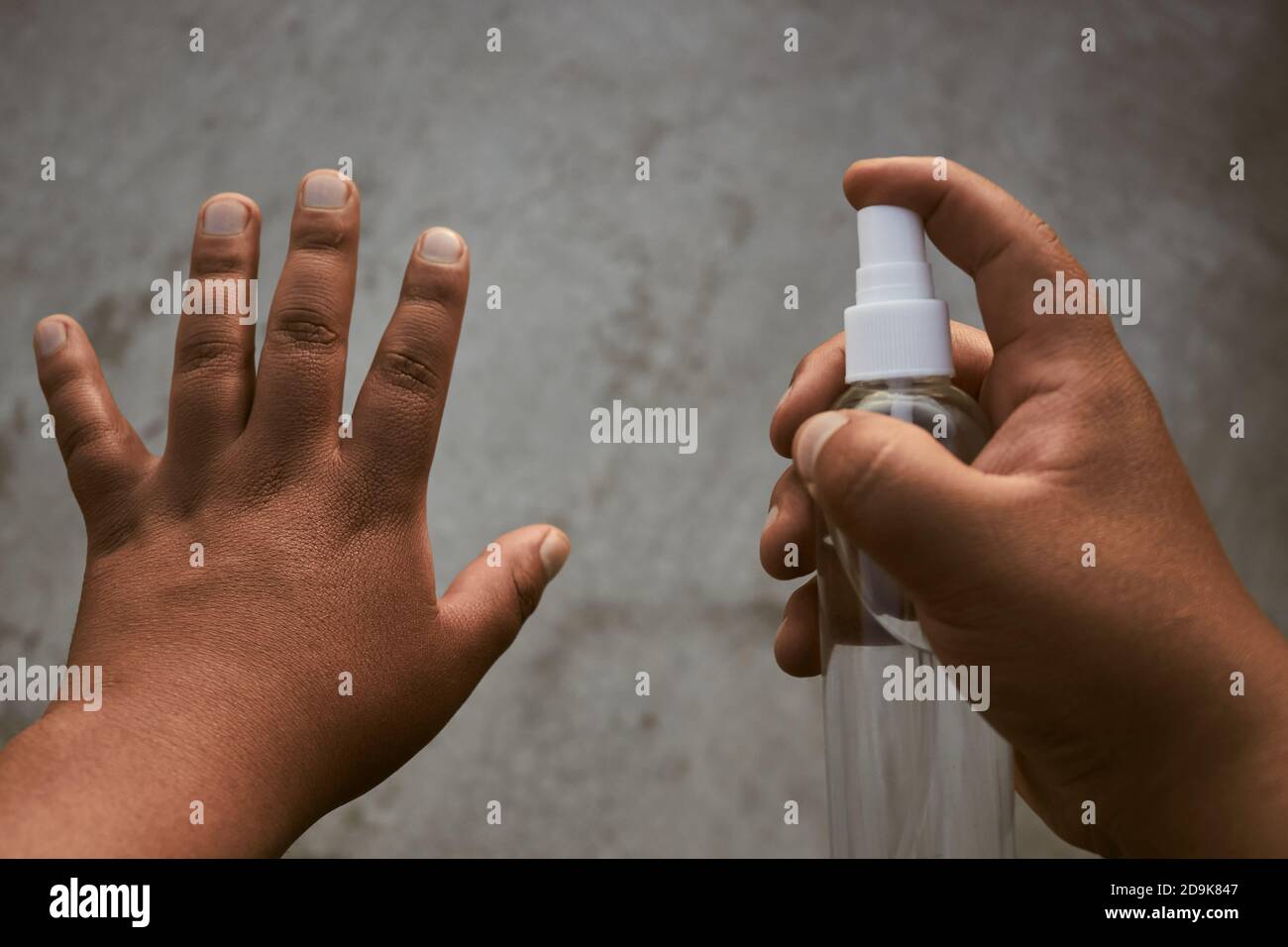 Kid disinfecting her hands with a medicinal alcohol Stock Photo - Alamy