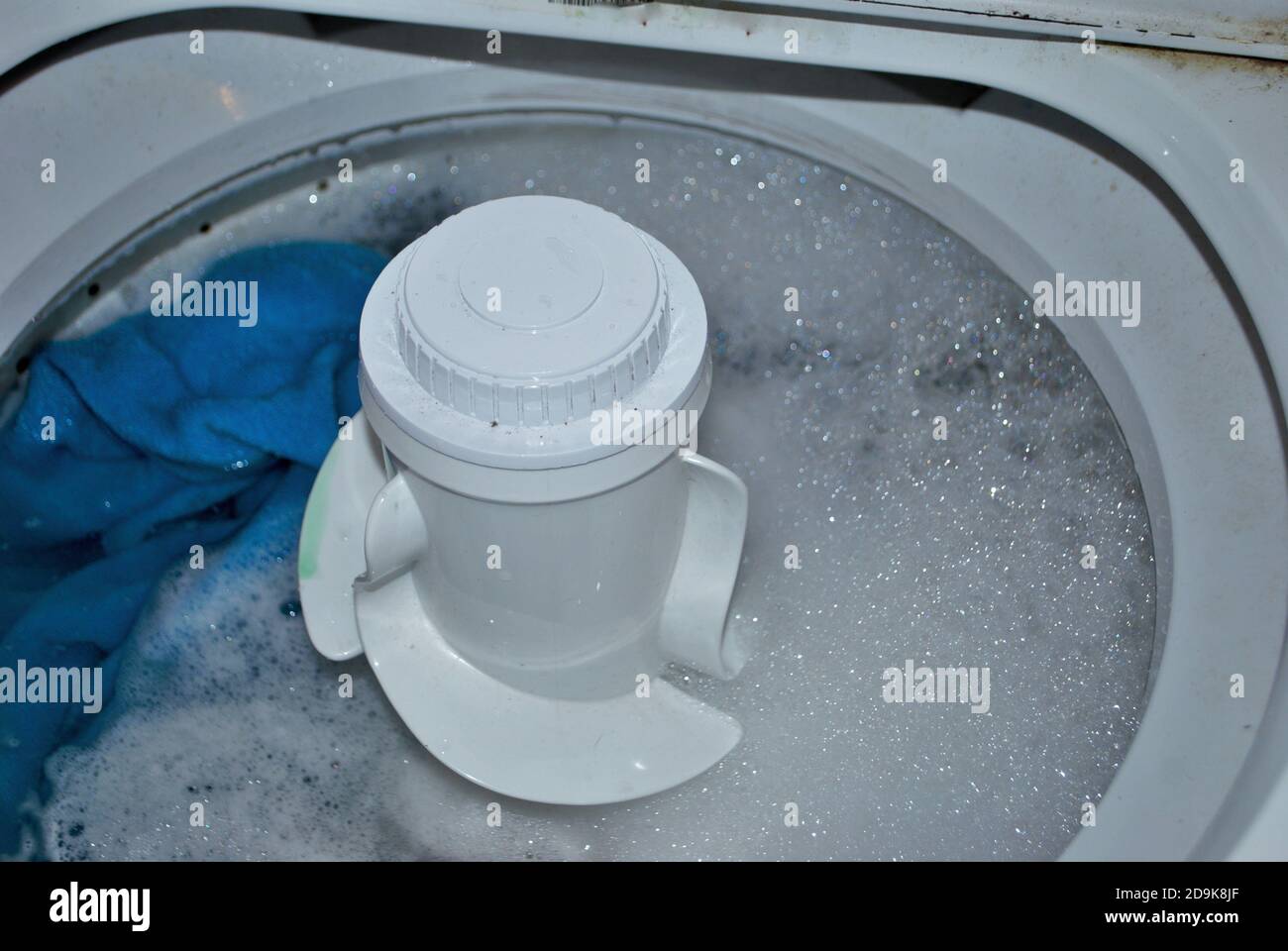 load of dirty towels in a washing machine full of water and soap ...