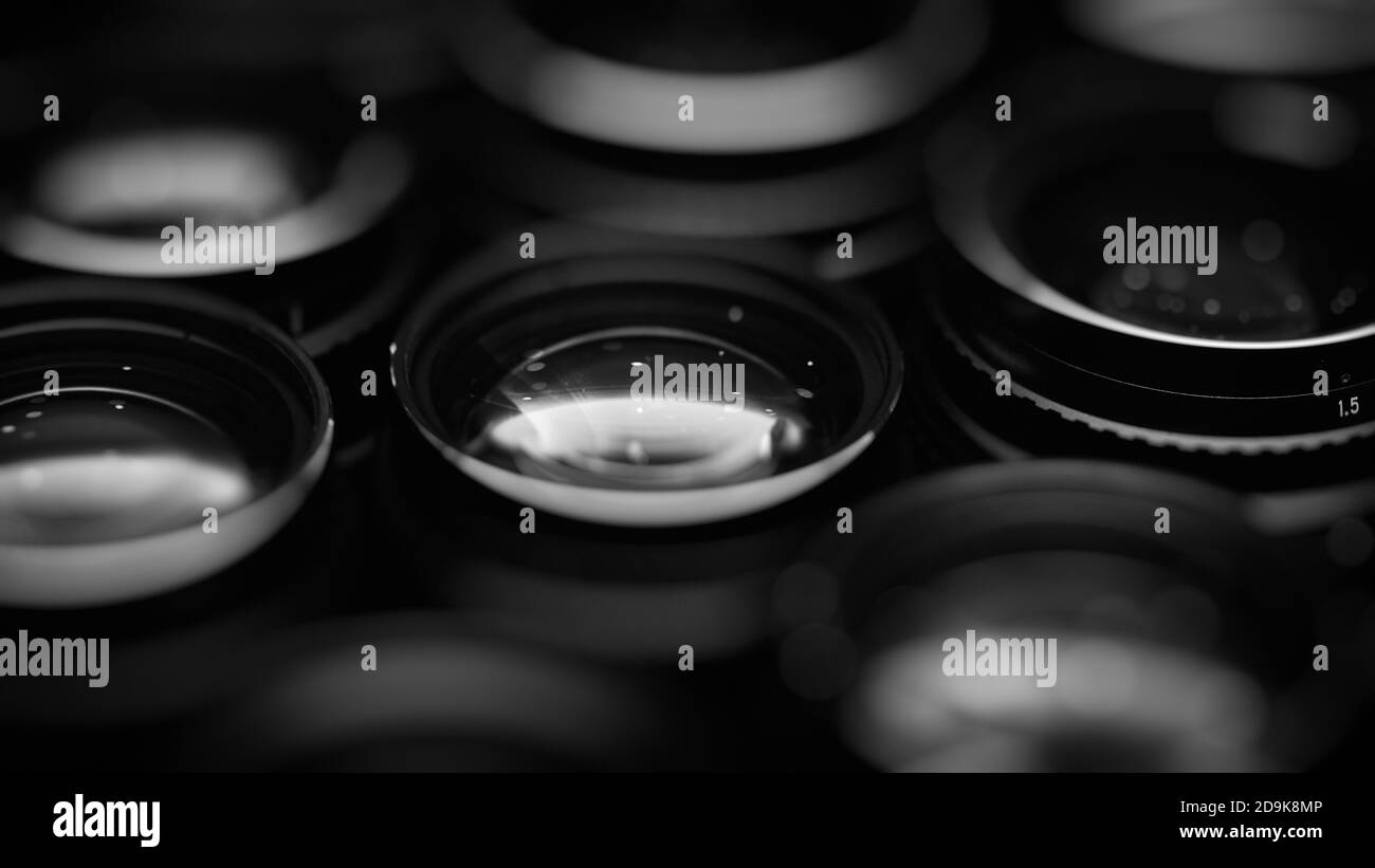 High-aperture camera lenses with reflections, low key image. High ...