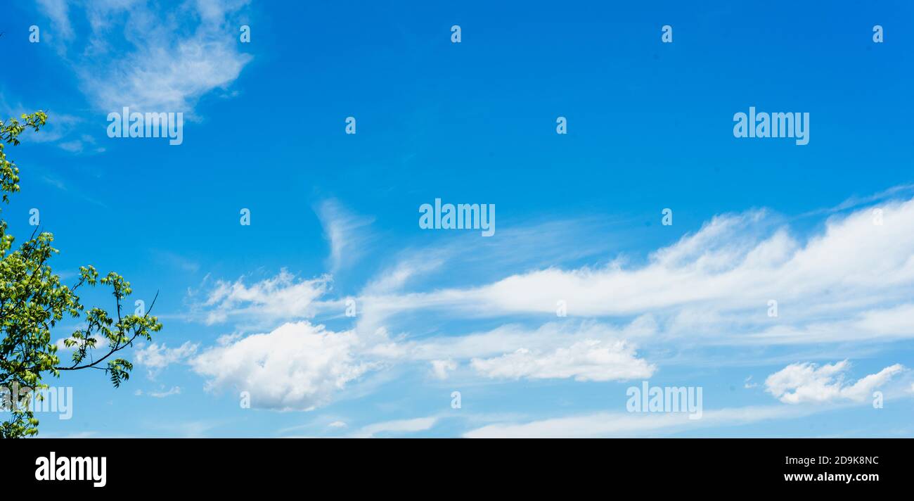 white wispy clouds on a bright clear blue sky Stock Photo - Alamy