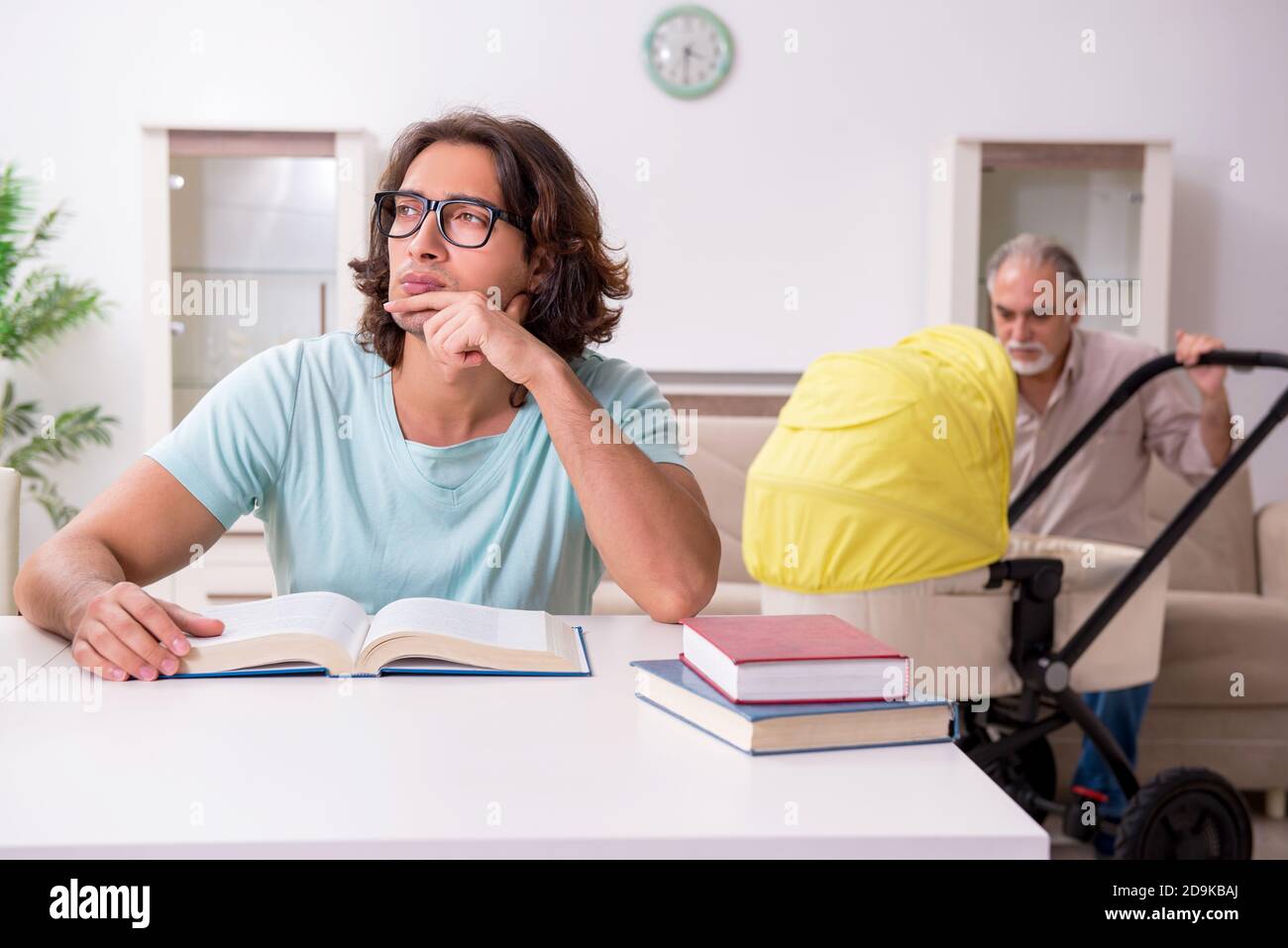 Old grandfather looking after newborn at home Stock Photo - Alamy