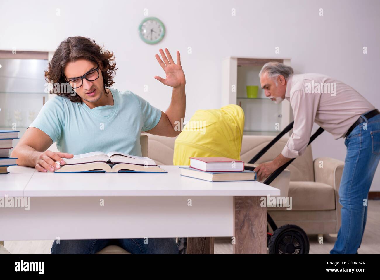 Old grandfather looking after newborn at home Stock Photo - Alamy