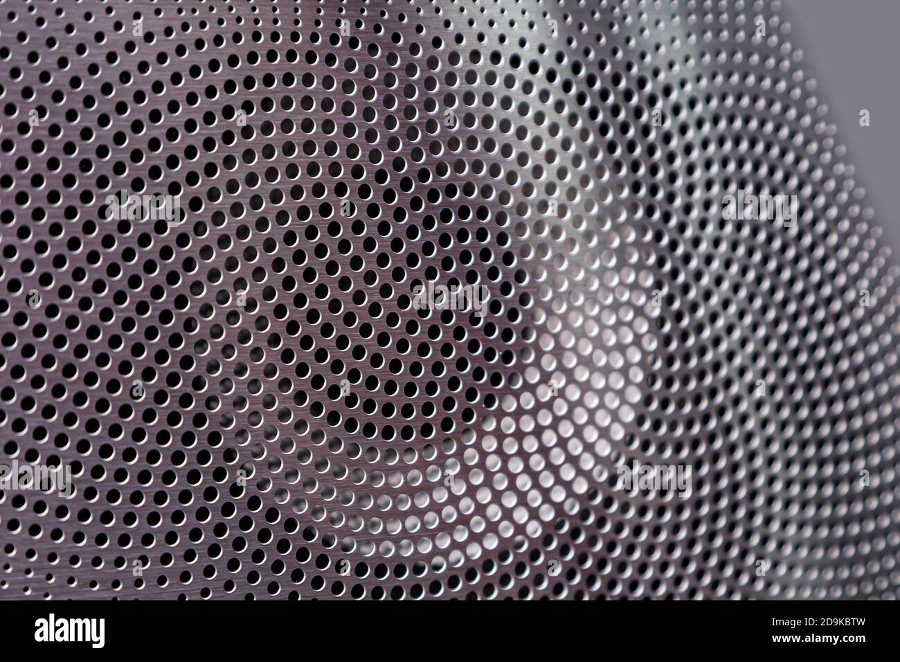 music column close-up. Metal part with holes of the same size, silver ...