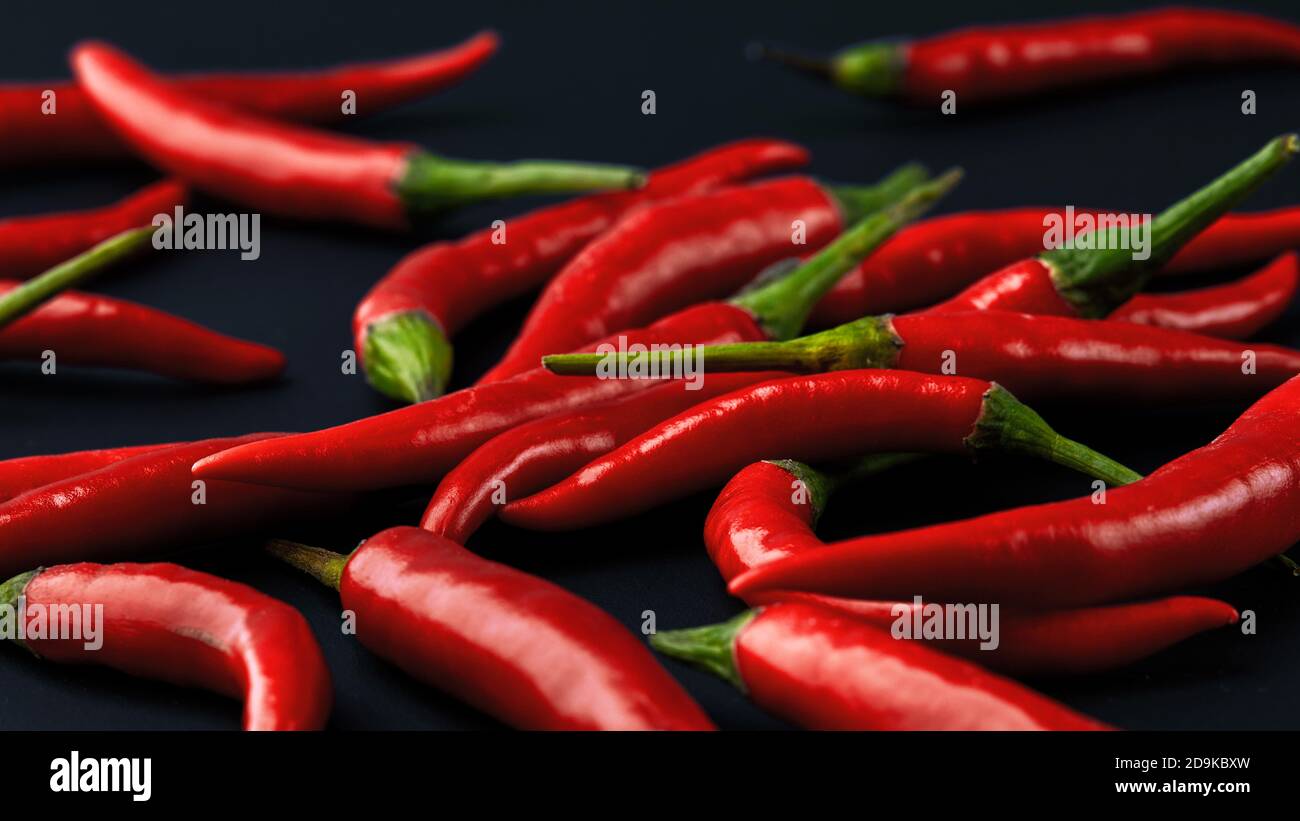 Red hot chili pepper on black background. Seasoning for real men. Fire ...