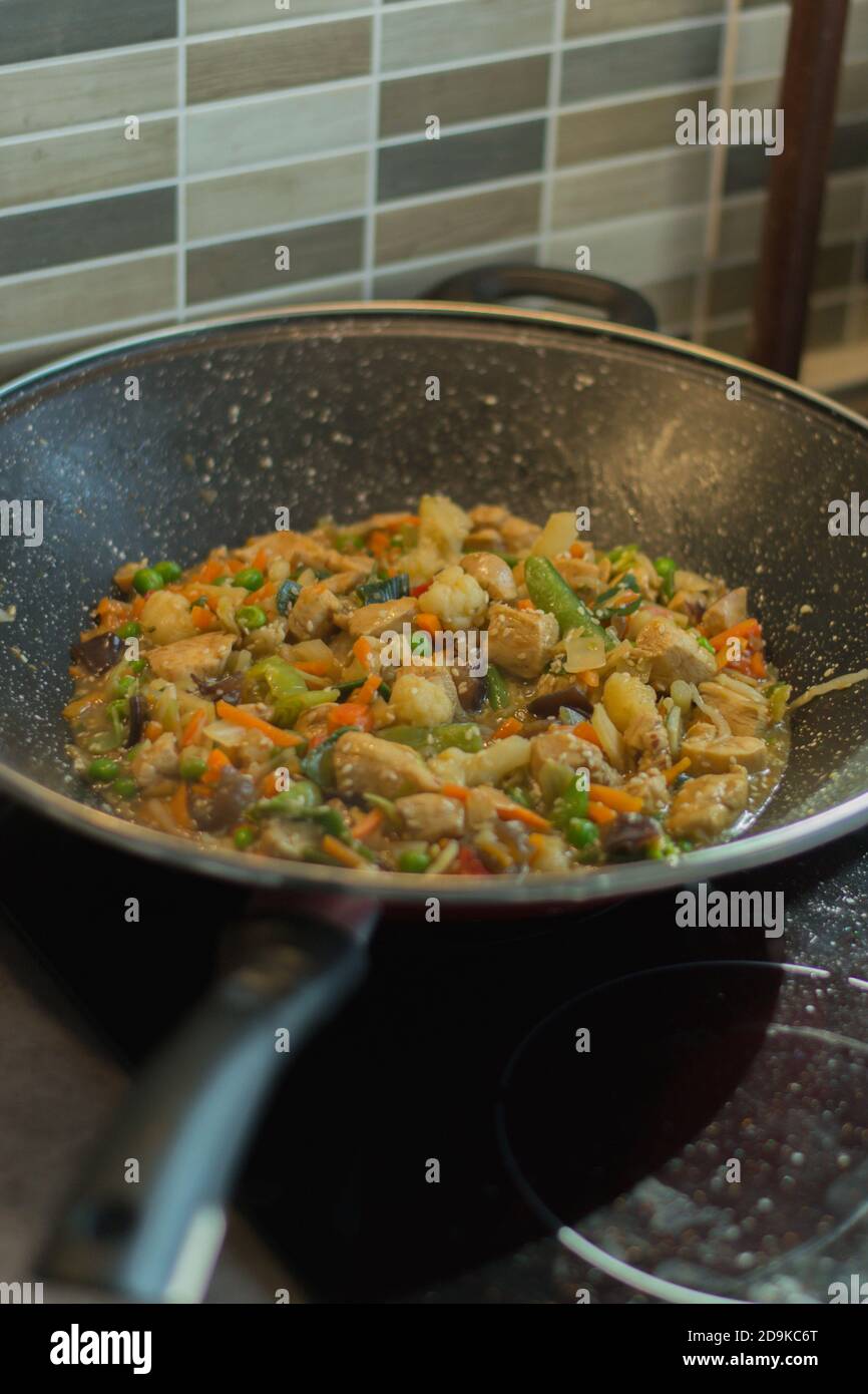 Vertical shot of chicken with vegetables in a pan Stock Photo - Alamy