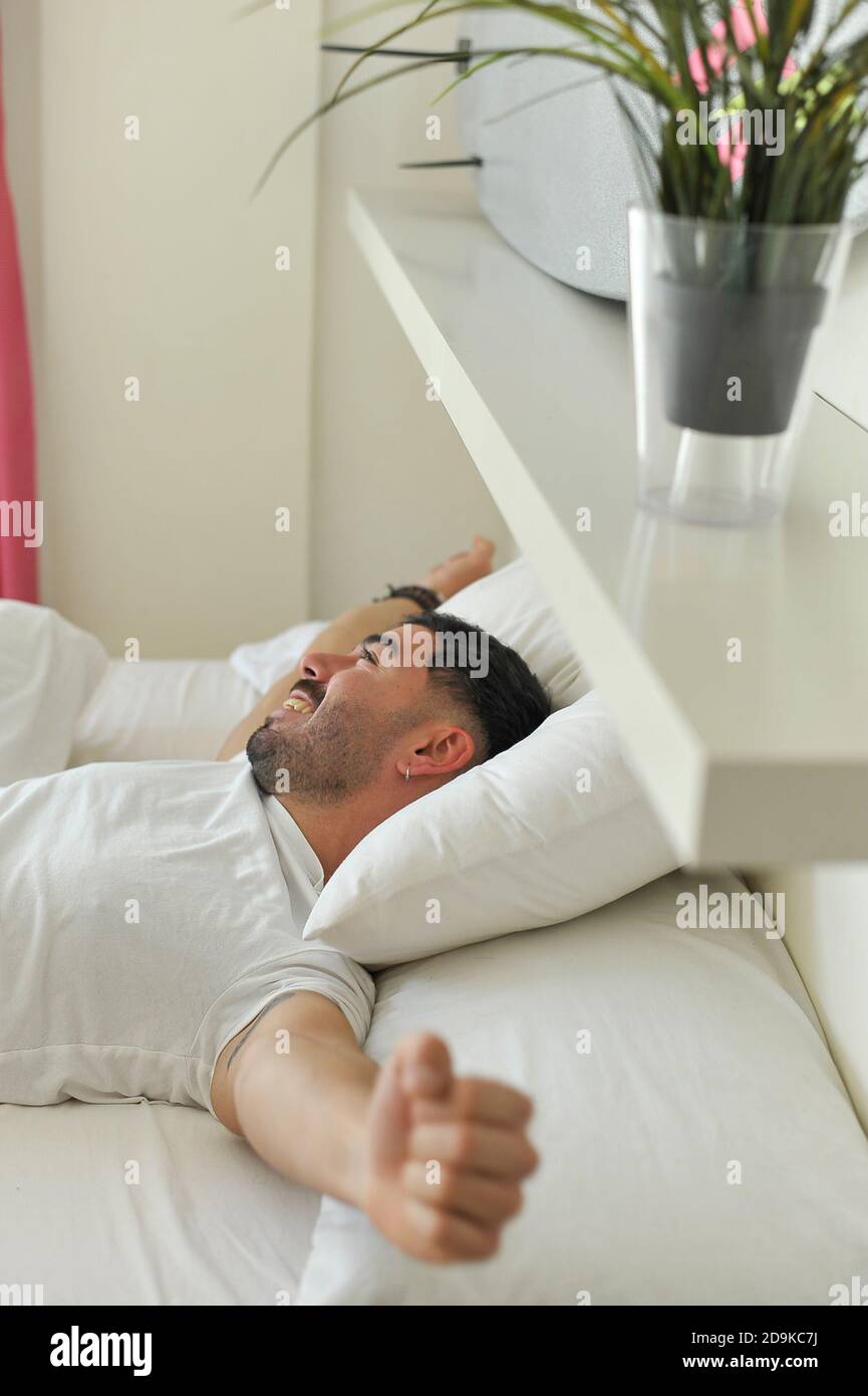 Man waking up in the morning happy Stock Photo - Alamy