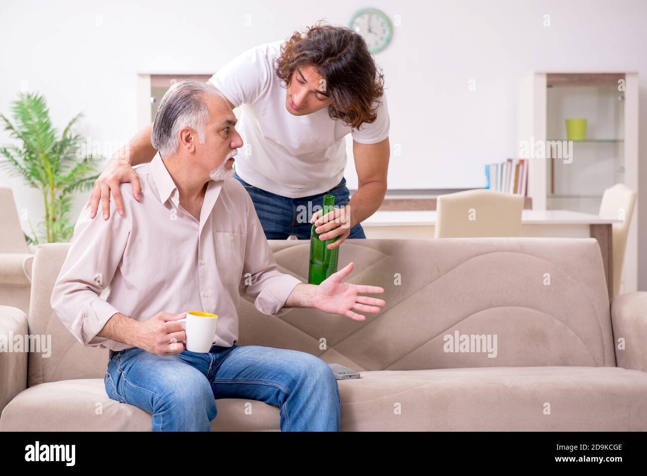 Drinking problems in the family between son and father Stock Photo - Alamy