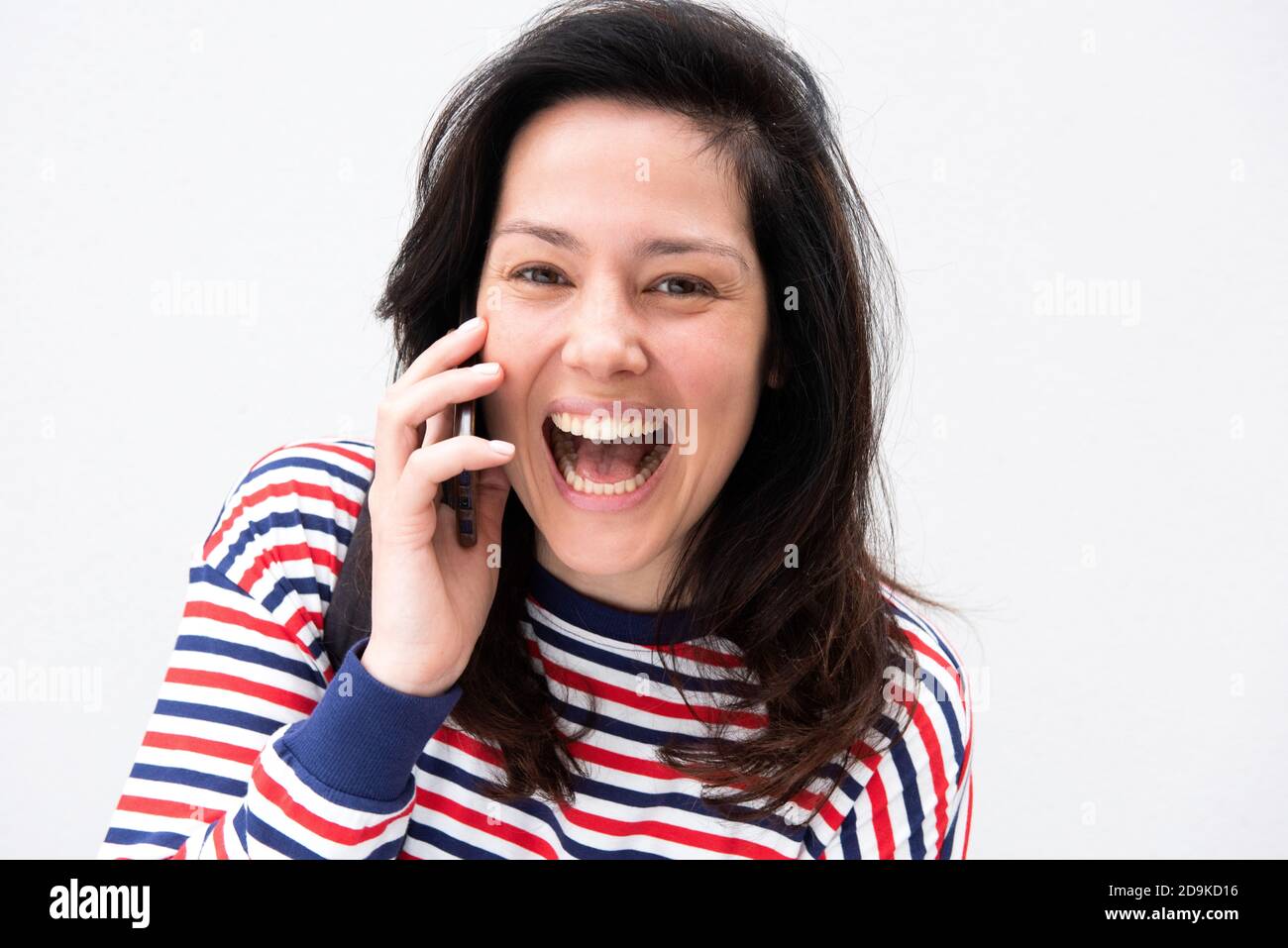 Close up portrait laughing young woman talking with cellphone against ...