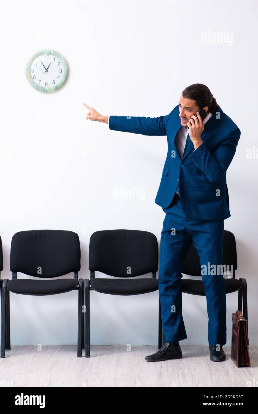 Businessman waiting for an interview at hall Stock Photo - Alamy