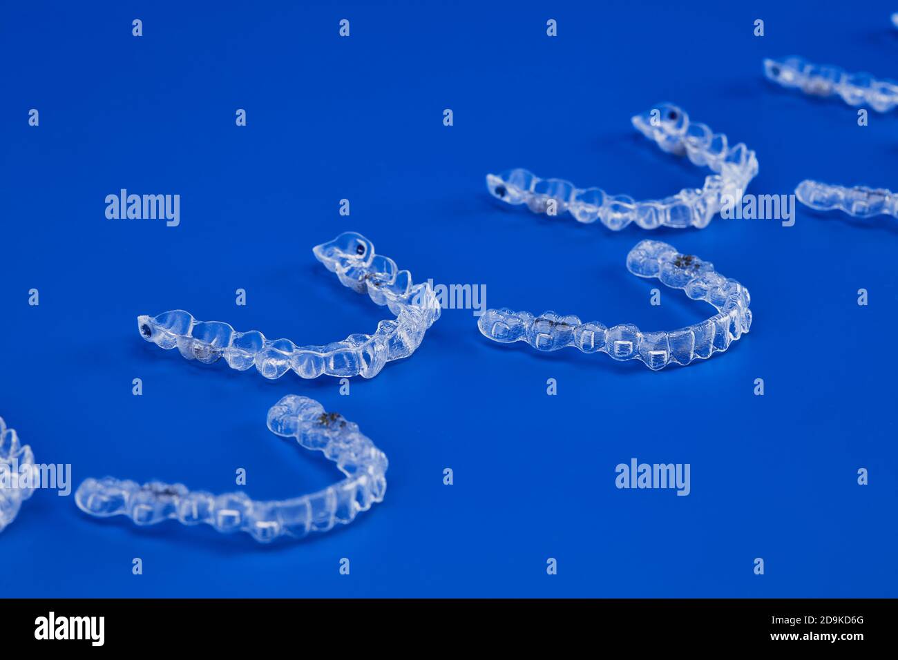 Invisible orthodontics cosmetic brackets on blue background, tooth ...